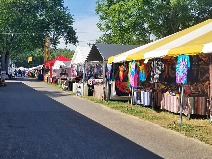 Rows of vibrant merchandise under summer skies—Friendship's market transforms ordinary fields into extraordinary shopping adventures.