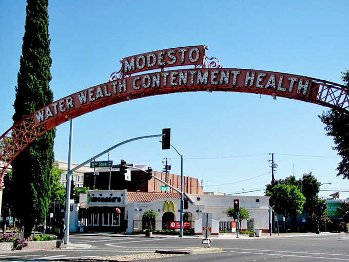 The iconic Modesto arch proudly announces "Water, Wealth, Contentment, Health"—the world's most optimistic welcome sign.
