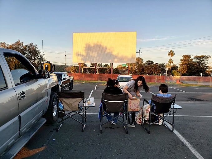 Movie night picnic in progress! This family knows the secret to drive-in success: good food, comfy chairs, and the best outdoor theater in Concord.