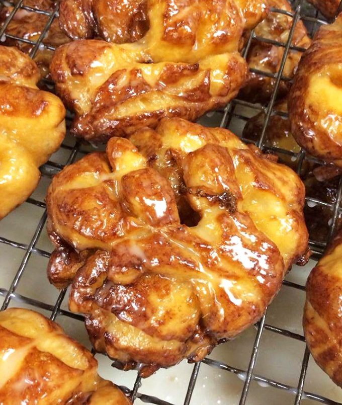 These apple fritters aren't just fried dough – they're edible works of art with a glaze so perfect it makes Renaissance painters jealous.