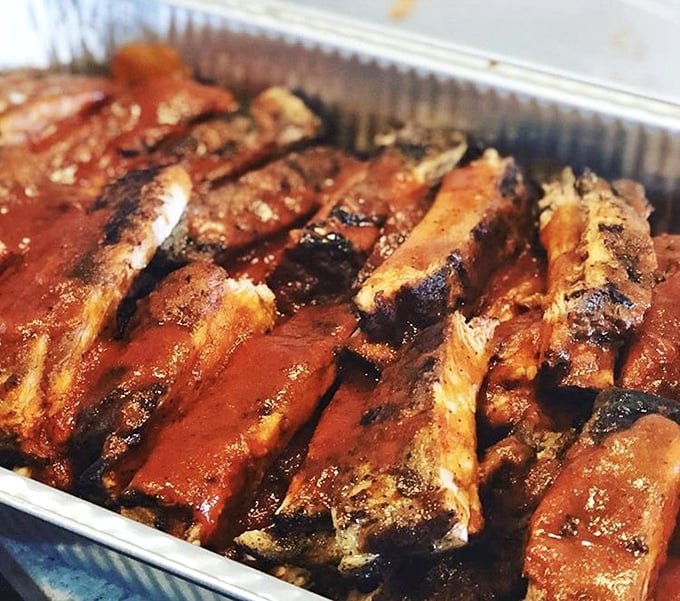 These ribs glisten like mahogany jewels, each one promising that perfect bite between tender and toothsome.