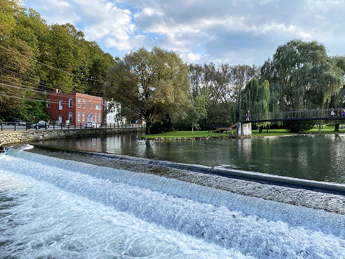 The waterfront walkway offers nature's soundtrack—rushing water creating both tranquility and energy in the heart of town.