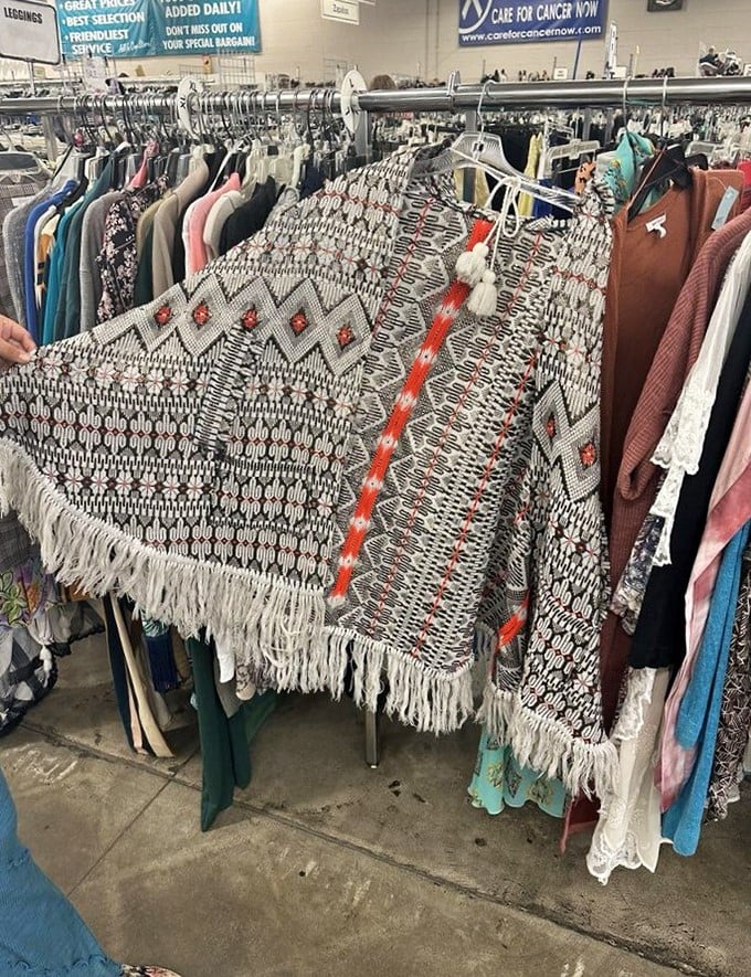 This isn't just a clothing rack – it's a textile time machine. That fringed poncho could have been at Woodstock or just waiting for your next music festival adventure.