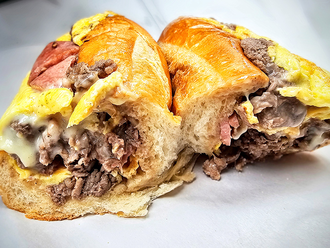 Behold the star of the show: thinly sliced ribeye, perfectly melted cheese, and a roll that deserves its own fan club.