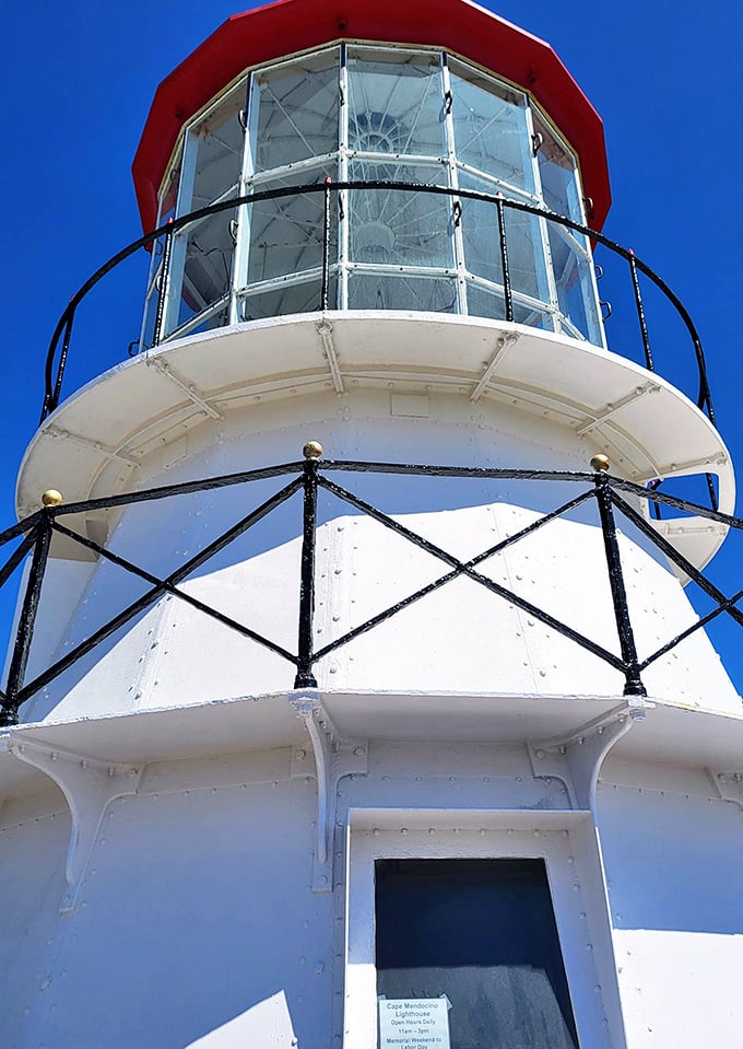 That distinctive red cap isn't just for show—it housed the original Fresnel lens that once guided ships through treacherous waters.