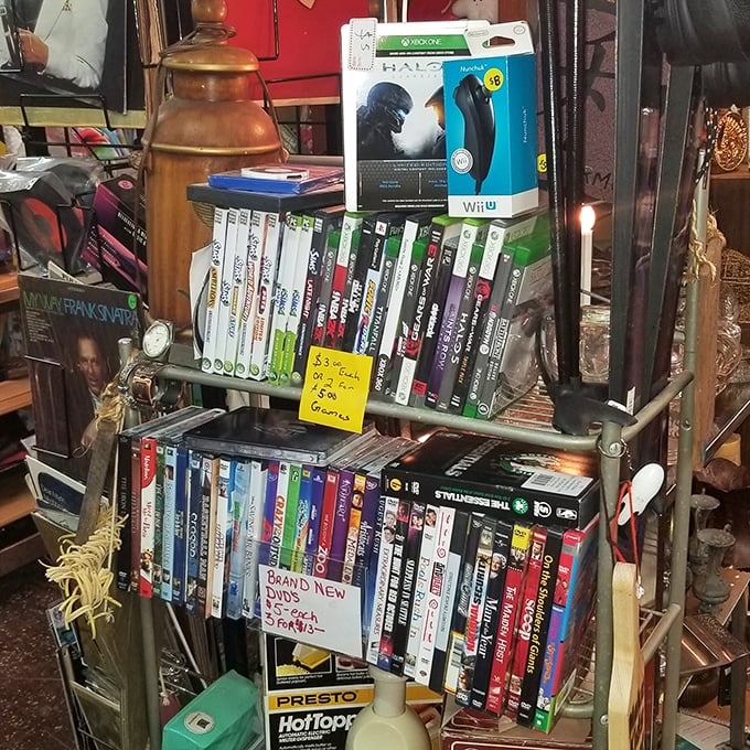 Gaming history lines these shelves, where yesterday's cutting-edge entertainment awaits a second life in someone's living room. That Halo box brings back memories!