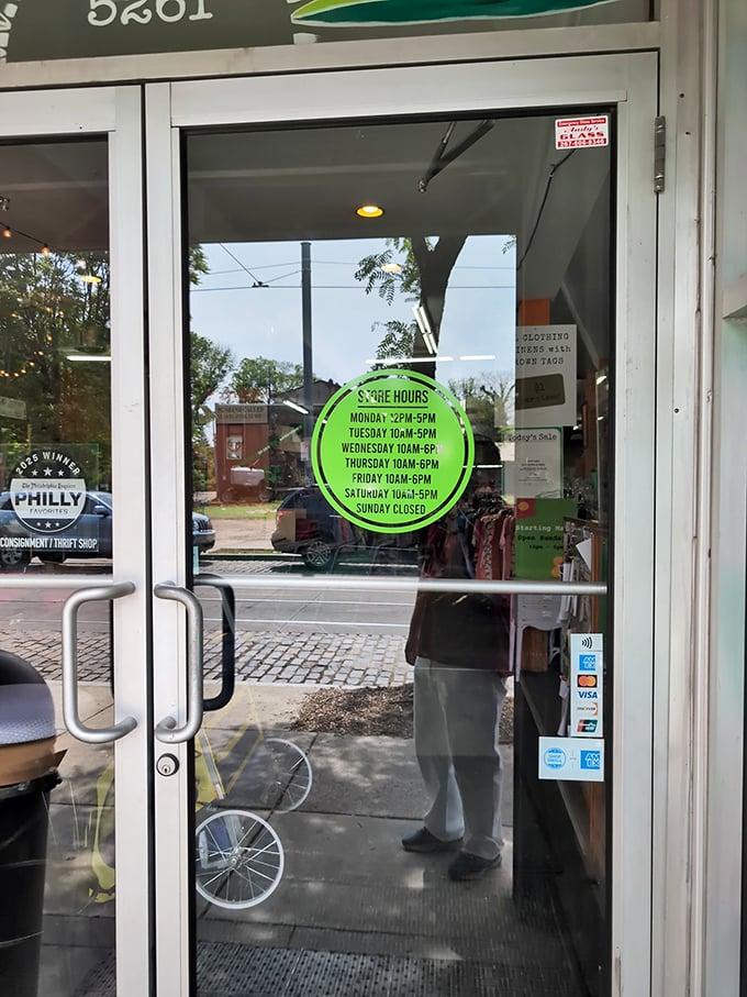 Store hours displayed on a bright green circle—the portal to bargain paradise awaits six days a week. Sunday is for counting your savings.