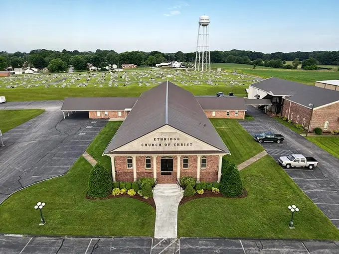 The Ethridge Church of Christ stands as a serene landmark amid the rolling Tennessee landscape, a peaceful counterpoint to the bustling Amish farms nearby.