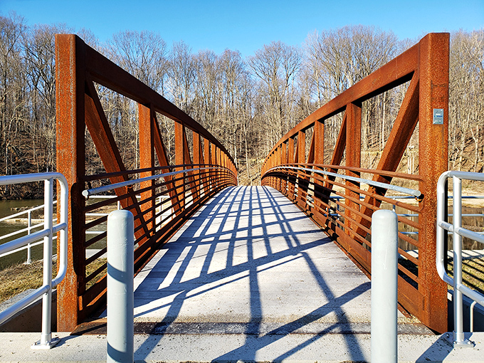 This rustic footbridge isn't just functional—it's an invitation to adventure, complete with geometric shadows playing across your path.