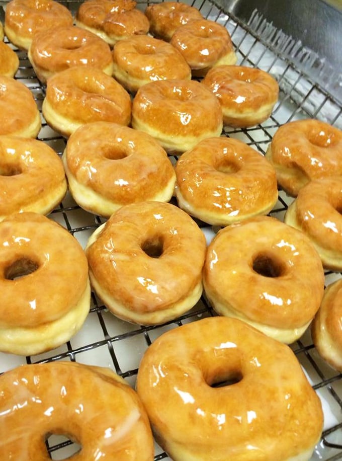 These glazed beauties aren't just donuts—they're edible sunshine with the perfect balance of airy interior and that signature crackling glaze.