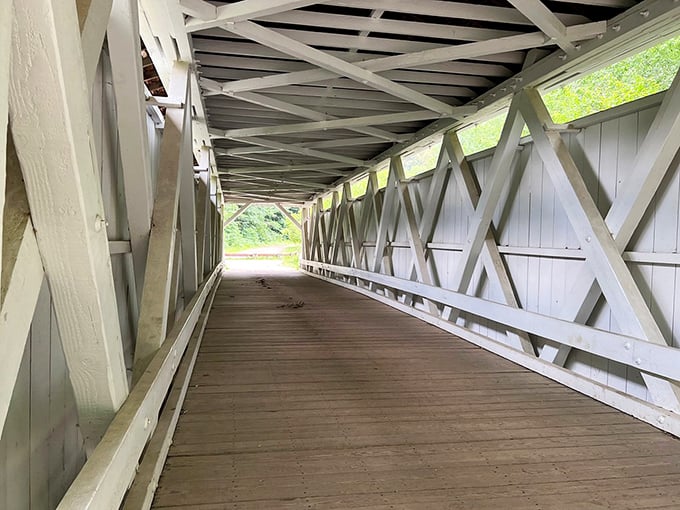 Inside reveals the true genius—a lattice truss design that's both architectural marvel and practical solution for spanning Furnace Run.