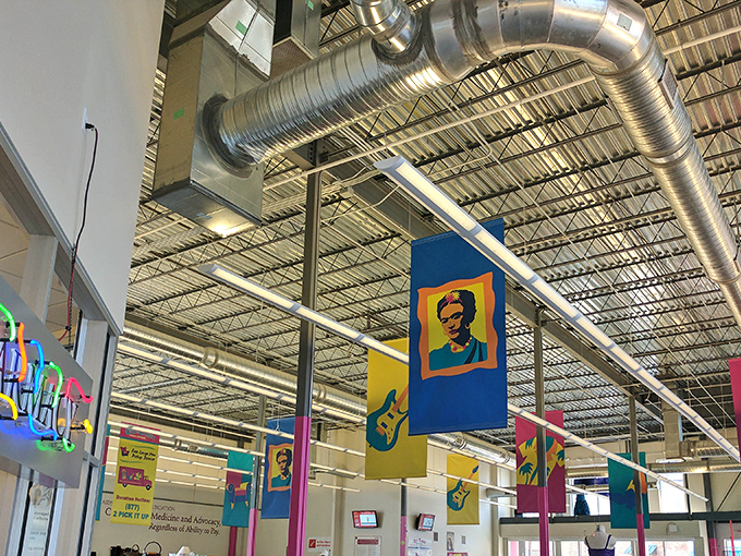 Look up and you'll spot pop art-inspired banners featuring cultural icons hanging from the industrial ceiling—a hint that this isn't your grandmother's thrift store.
