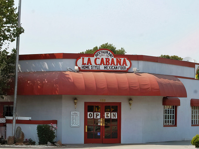 La Cabaña's vibrant red awning isn't just a sunshade—it's a beacon calling to everyone whose soul needs authentic Mexican comfort food. 
