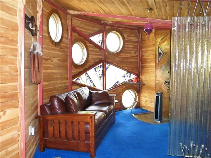 That leather couch has witnessed more double-takes than a magician's convention in this timber-wrapped wonderland.
