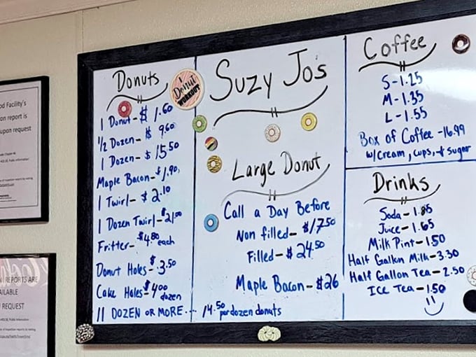 The handwritten menu board tells you everything you need to know—this place prioritizes donuts over design, substance over style.