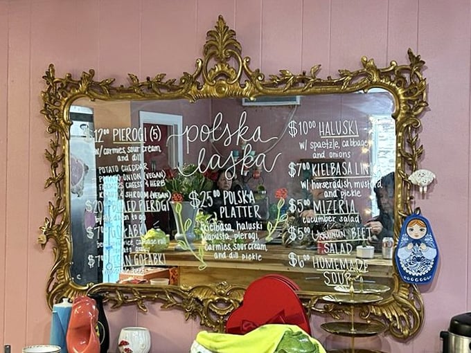 The ornate gilded mirror menu board is the royal announcement system for humble Polish classics. No fancy descriptions needed when the food speaks for itself.