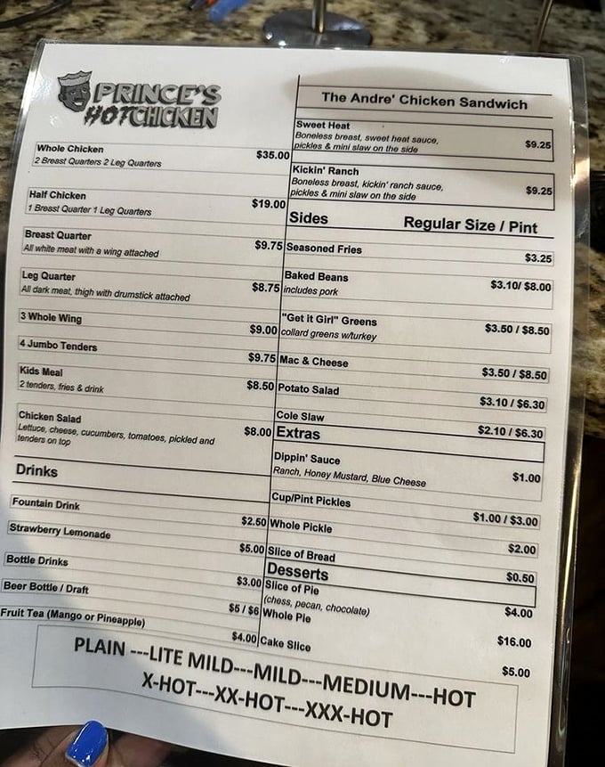 The menu board tells a story of heat levels that range from "I'm just visiting Nashville" to "I need to prove something to myself." Choose wisely, friends.