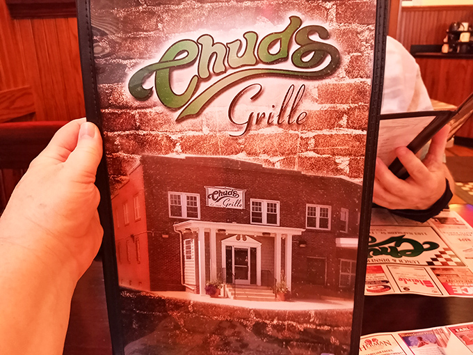 The menu at Chud's isn't just a list of food—it's a roadmap to happiness, carefully preserved in this nostalgic holder.