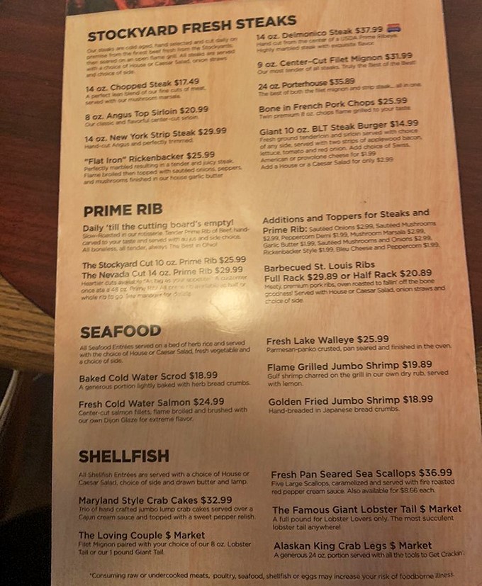 This menu isn't just a list of options – it's a carnivore's dream journal with "Stockyard Fresh Steaks" and seafood treasures that'll make your wallet nervous but your stomach grateful.