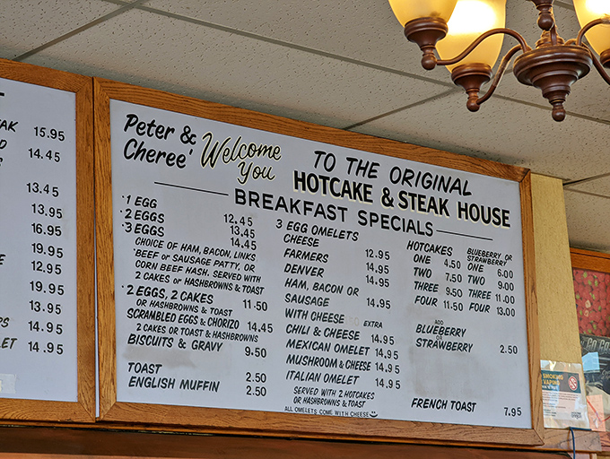 The wall menu—a sacred text of breakfast possibilities—offers salvation to hungry souls at any hour of day or night.