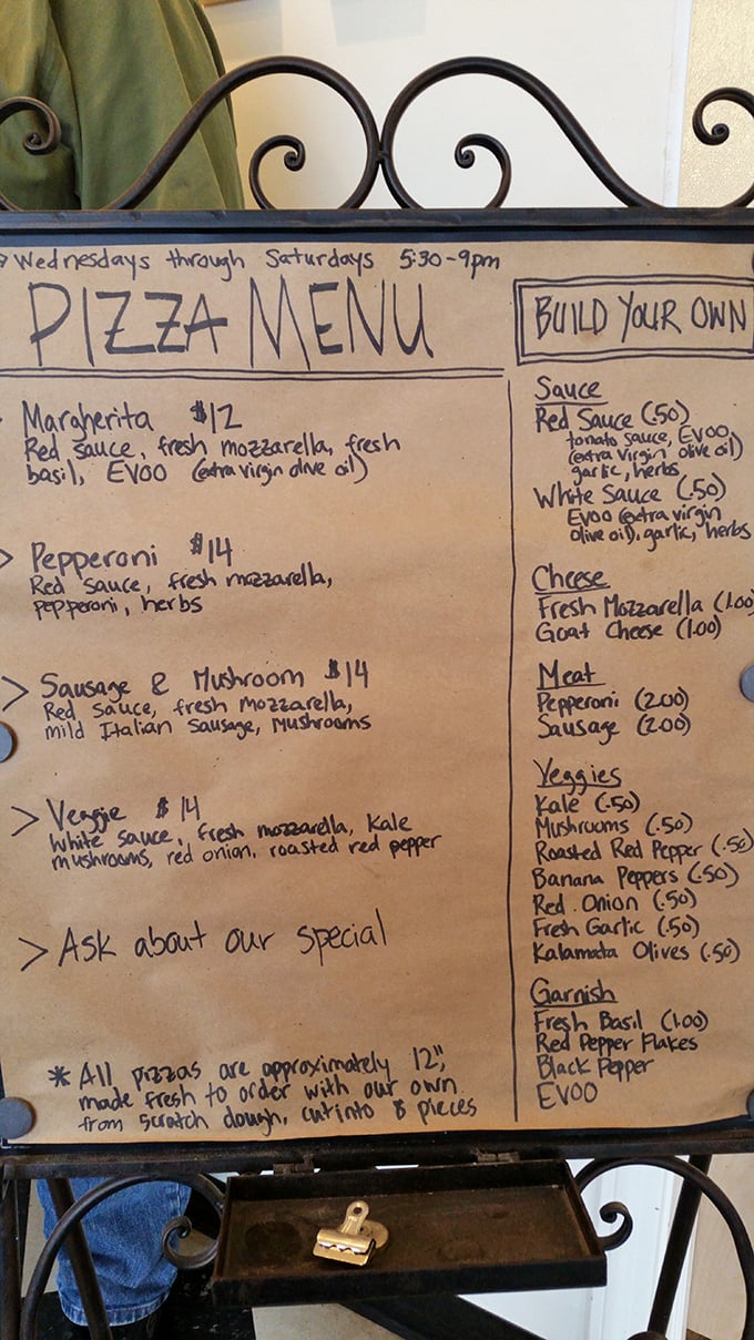 Handwritten menus are like love letters to food – this one promises pizza paradise at reasonable prices.