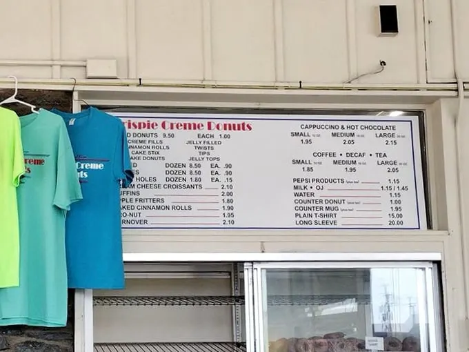 A menu board that proves the best things in life are simple, affordable, and covered in glaze. No avocado toast in sight.