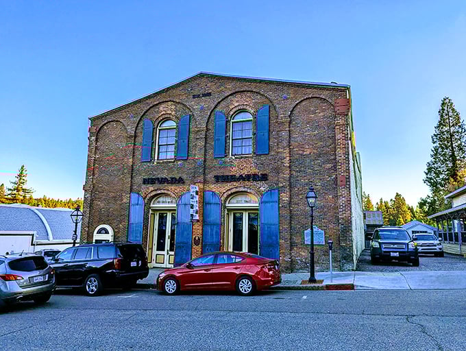 This isn't just a brick building—it's a time capsule with blue shutters, housing stories of Nevada City's colorful past and vibrant present.