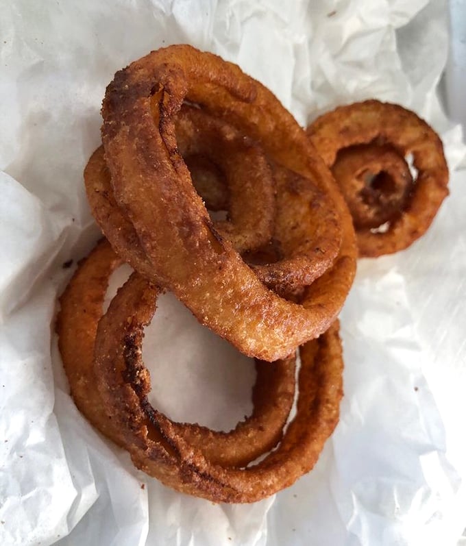 Golden halos of happiness. These aren't just onion rings—they're crispy, hand-battered treasures that people cross county lines to devour.