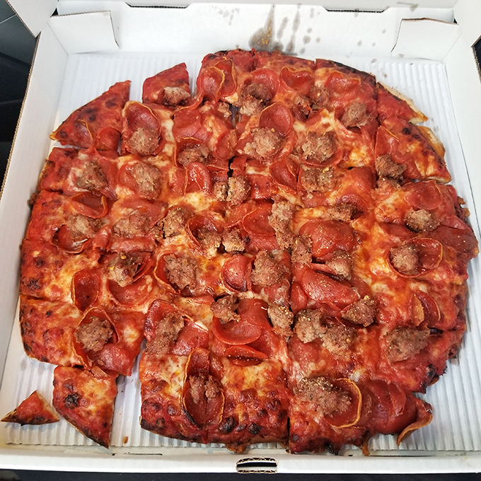 The legendary pepperoni and sausage pizza – where crispy-edged pepperoni cups cradle savory oils and homemade sausage steals the show.