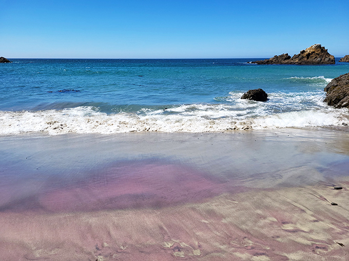 Purple sand that looks like it was colored by a cosmic crayon. Nature's most unexpected beach palette proves reality can outdo even your most filtered Instagram dreams.