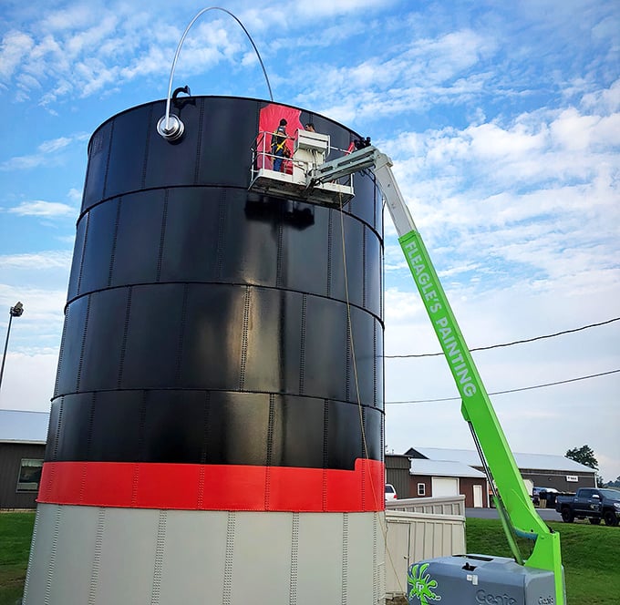 Maintenance day at the world's largest paint can. Ironically, it takes several smaller cans of paint to keep this giant looking fresh.