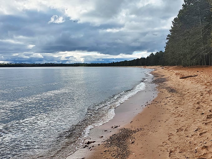 The beach that makes Wisconsinites say, "Who needs the Caribbean?" Golden sands meet crystal waters under a moody sky—pure Great Lakes drama at its finest.