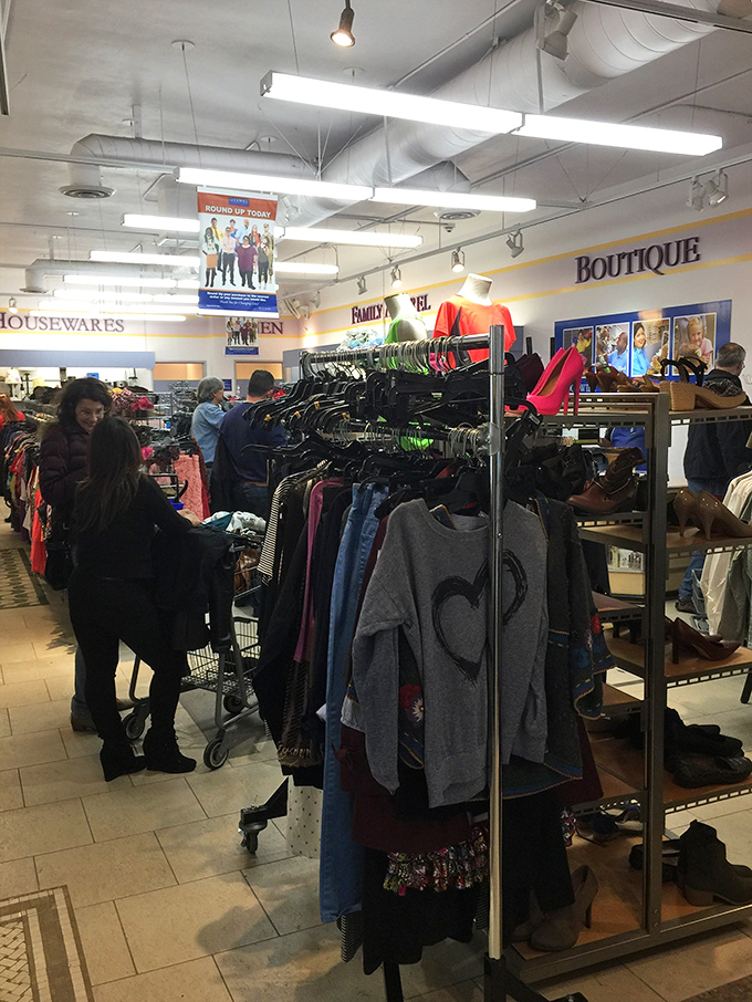 The thrill of the hunt in action – shoppers navigate racks with the focused determination of archaeologists uncovering ancient artifacts.