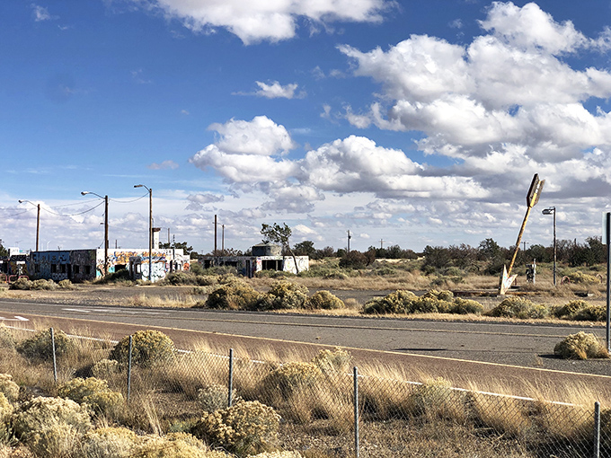 From the highway, this roadside relic beckons travelers with the irresistible charm of authentic Americana decay.