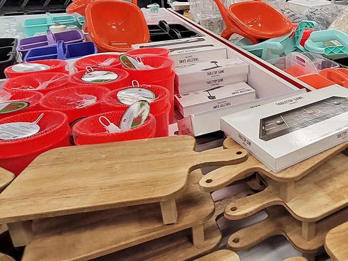 Wooden cutting boards and colorful containers await new kitchens. That stack of pine boards isn't just kitchen equipment—it's a dinner party waiting to happen at one-third the usual cost.