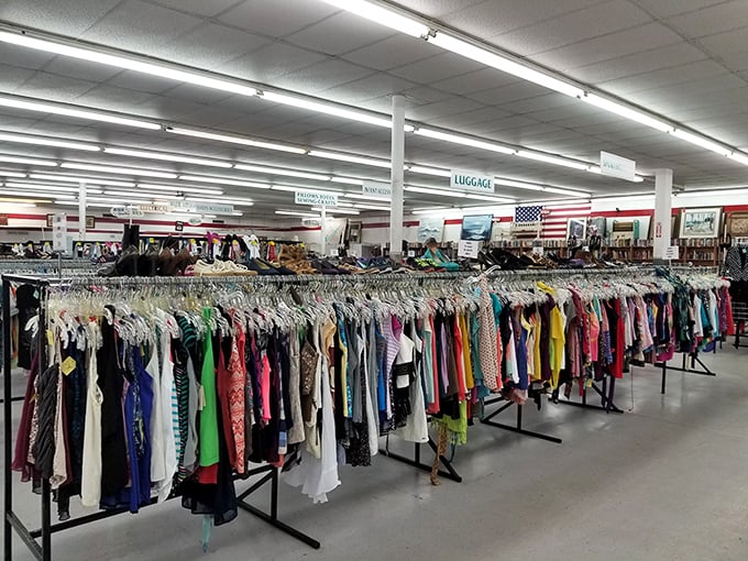 A rainbow of possibilities hangs in orderly rows, each garment whispering tales of its former life while awaiting its next chapter.