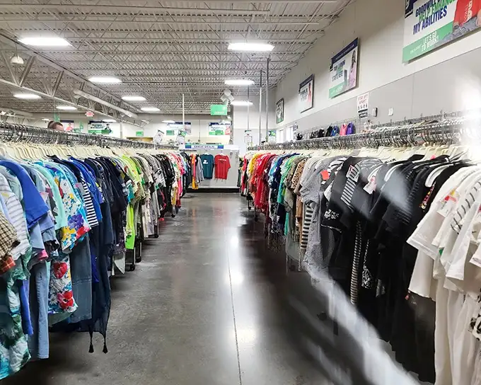 The clothing section stretches like a textile rainbow. Each rack tells a different story, with characters ranging from casual tees to formal attire.
