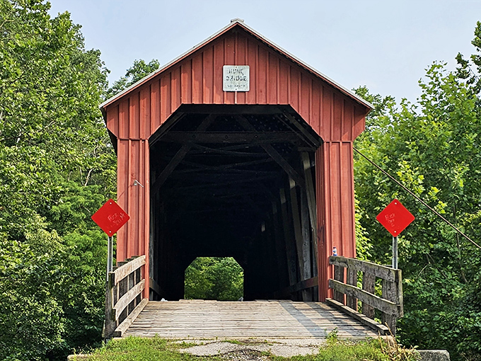 This crimson-colored covered bridge isn't just picturesque—it's a time machine to simpler days when Sunday drives were an actual event.