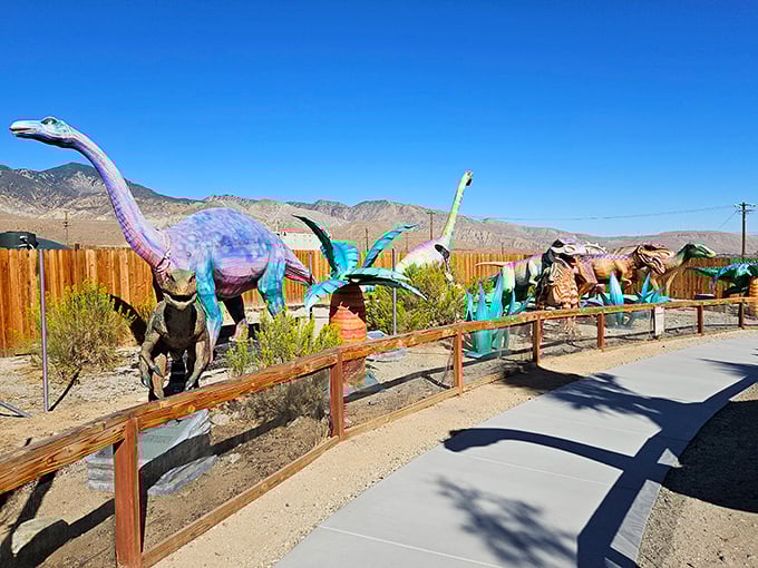 A prehistoric parade of colorful creatures stands at attention, their vibrant hues popping against the rugged mountain backdrop.