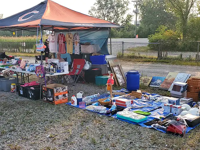 One vendor's carefully arranged chaos is another shopper's treasure map – notice the vintage frames and toy fire truck waiting for their forever homes.