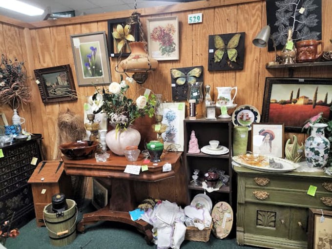 This vendor's booth is a masterclass in organized chaos—butterfly art, vintage vases, and antique furniture creating a perfectly curated treasure nest.