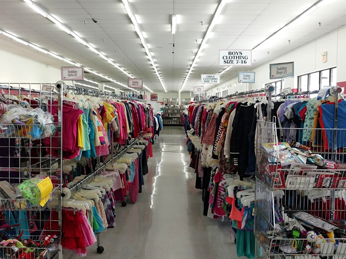 A kaleidoscope of children's clothing stretches toward the horizon. Each tiny garment represents a growth spurt that some parent's wallet is grateful to have missed.