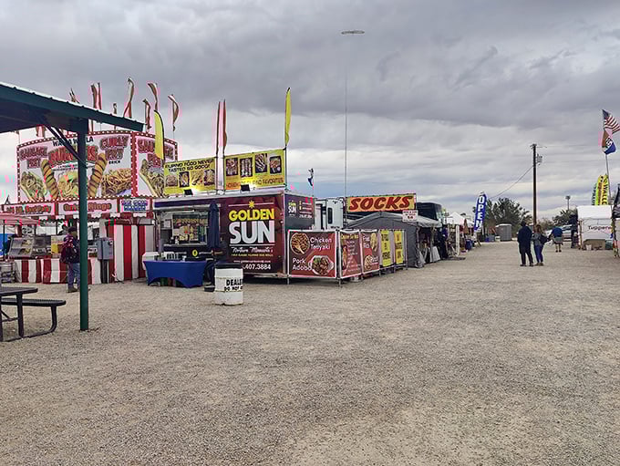 Food vendors line the dusty pathways, promising everything from "Golden Sun" delights to sock shopping—because who doesn't need both?