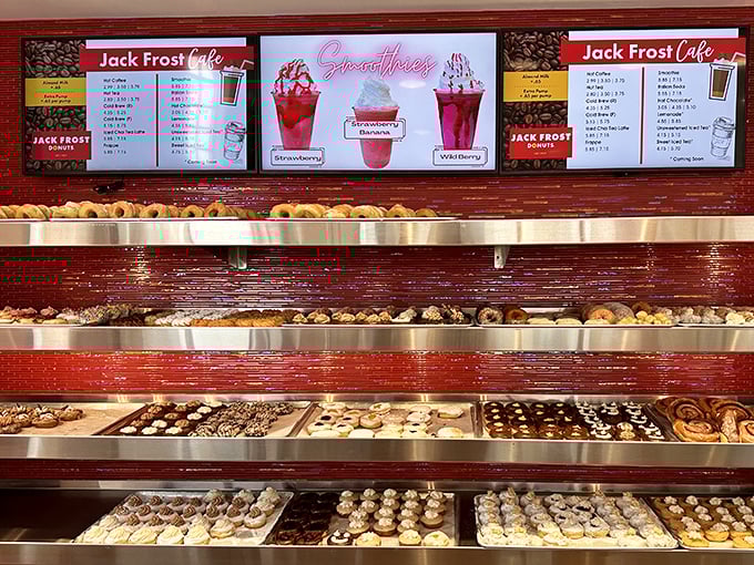 The menu board showcases strawberry smoothies alongside classic donuts – because sometimes you need something refreshing to cut through all that glorious fried dough.