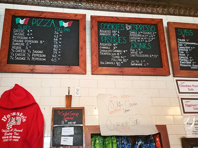 That menu board tells you everything you need to know about priorities here. Pizza, cookies, cannoli – the holy trinity of Italian comfort food.