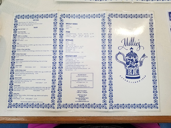 The blue and white menu reads like a breakfast manifesto, with the teapot logo promising refills that'll keep you caffeinated through life's important decisions.