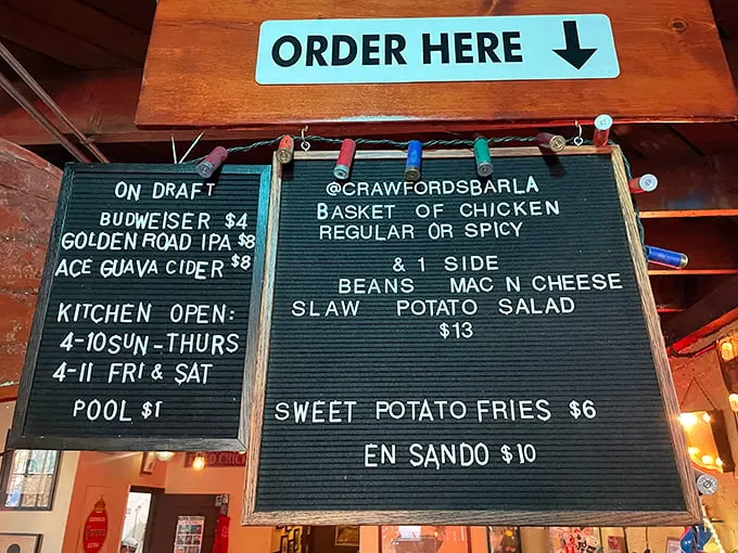 The letter board menu speaks the universal language of simplicity: chicken, sides, beer. No decoder ring required.