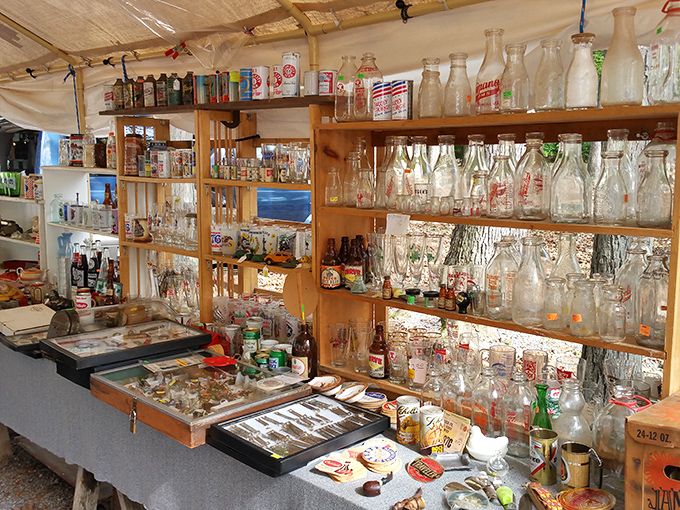 
Bottle collectors, prepare to hyperventilate! This vendor's meticulously organized display showcases decades of American beverage history, one glass container at a time. 
