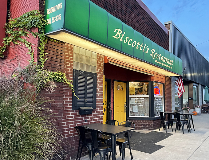 Biscotti's Restaurant isn't trying to be trendy—it's too busy being authentic. That bright yellow door promises comfort food that hugs you from the inside.