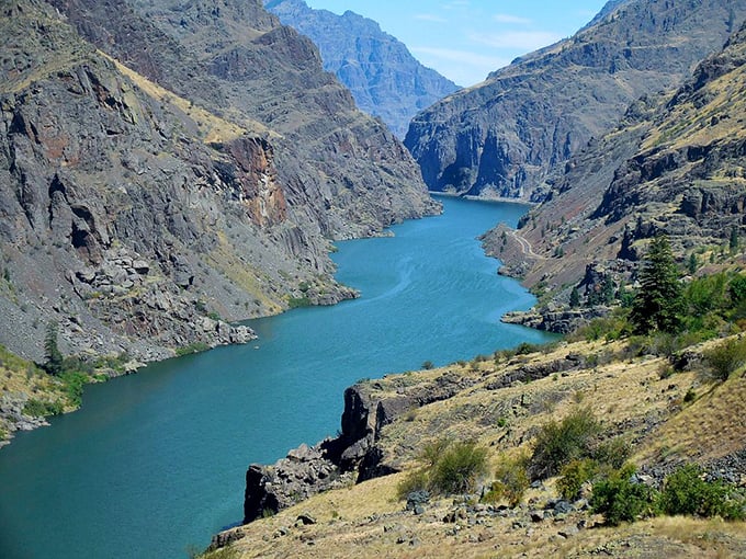 Rolling hills meet towering peaks in a landscape so perfect it seems almost fictional.